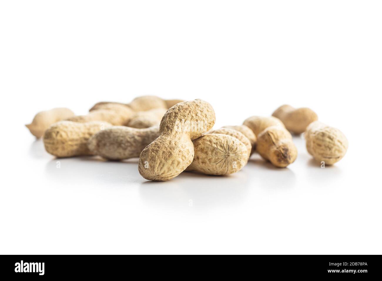 Tasty unpeeled peanuts isolated on white background Stock Photo - Alamy