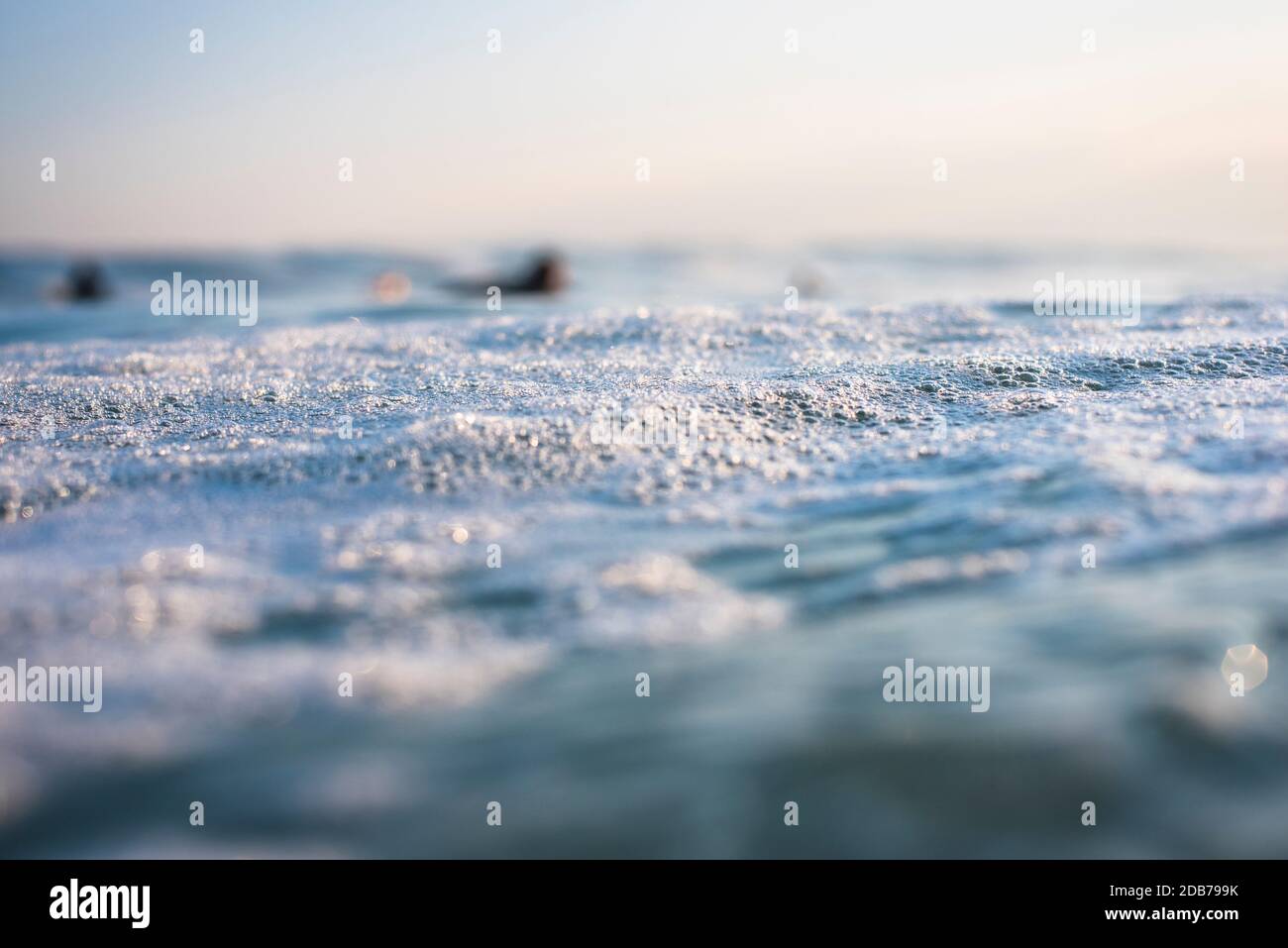 Whitewash bubble water detail from summer surf during golden hour in ...