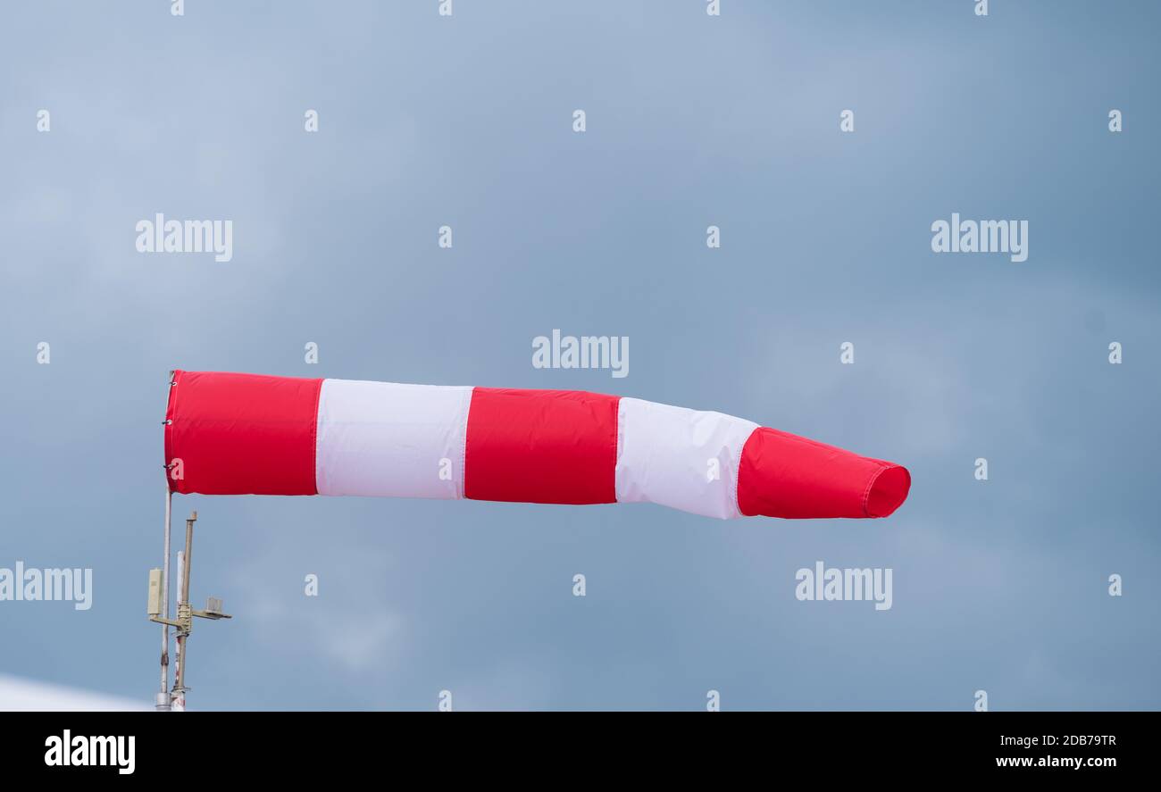 airport windsock against a blue background Stock Photo - Alamy