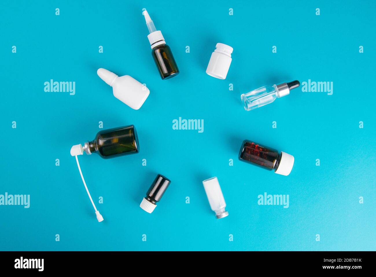 Different vials and sprays with medicines are laid out in the form of a ...