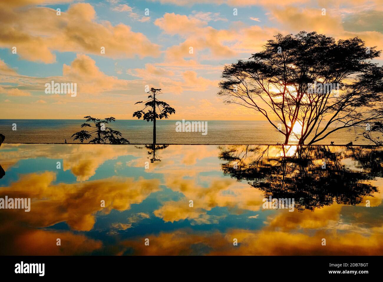 Clouds reflecting in shiny pond at sunset, Dominical, Costa Rica Stock ...