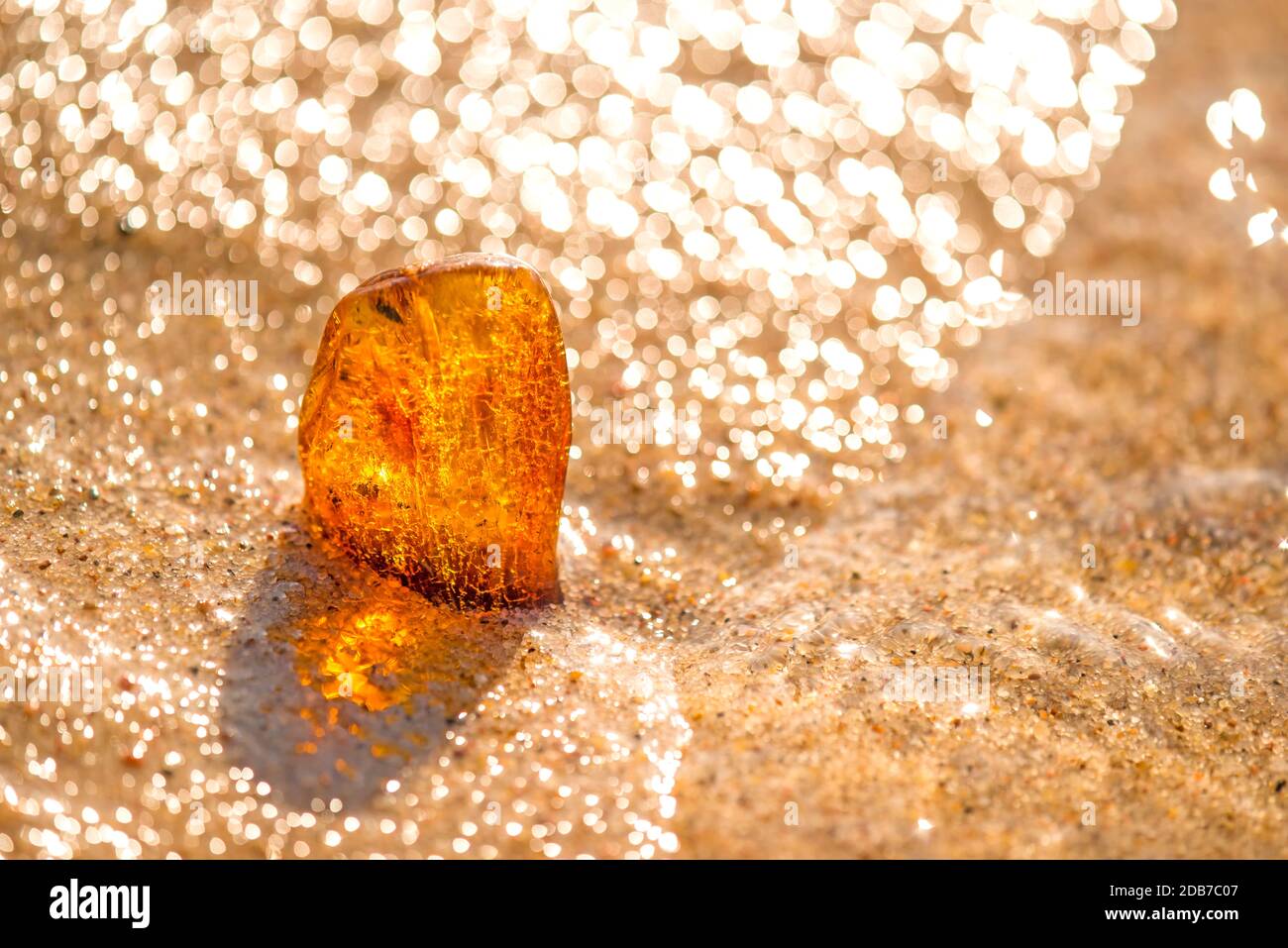 Amber on a beach of the Baltic Sea in the surf Stock Photo - Alamy