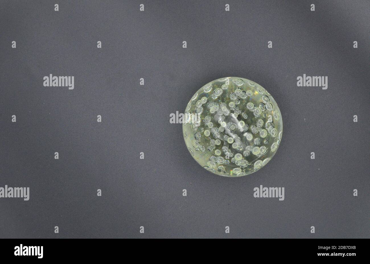 transparent glass ball full of air bubbles isolated on the black ...