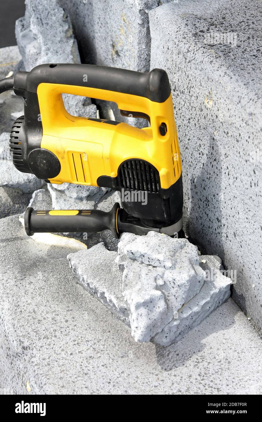 Yellow drilling machine for hard concrete work Stock Photo - Alamy