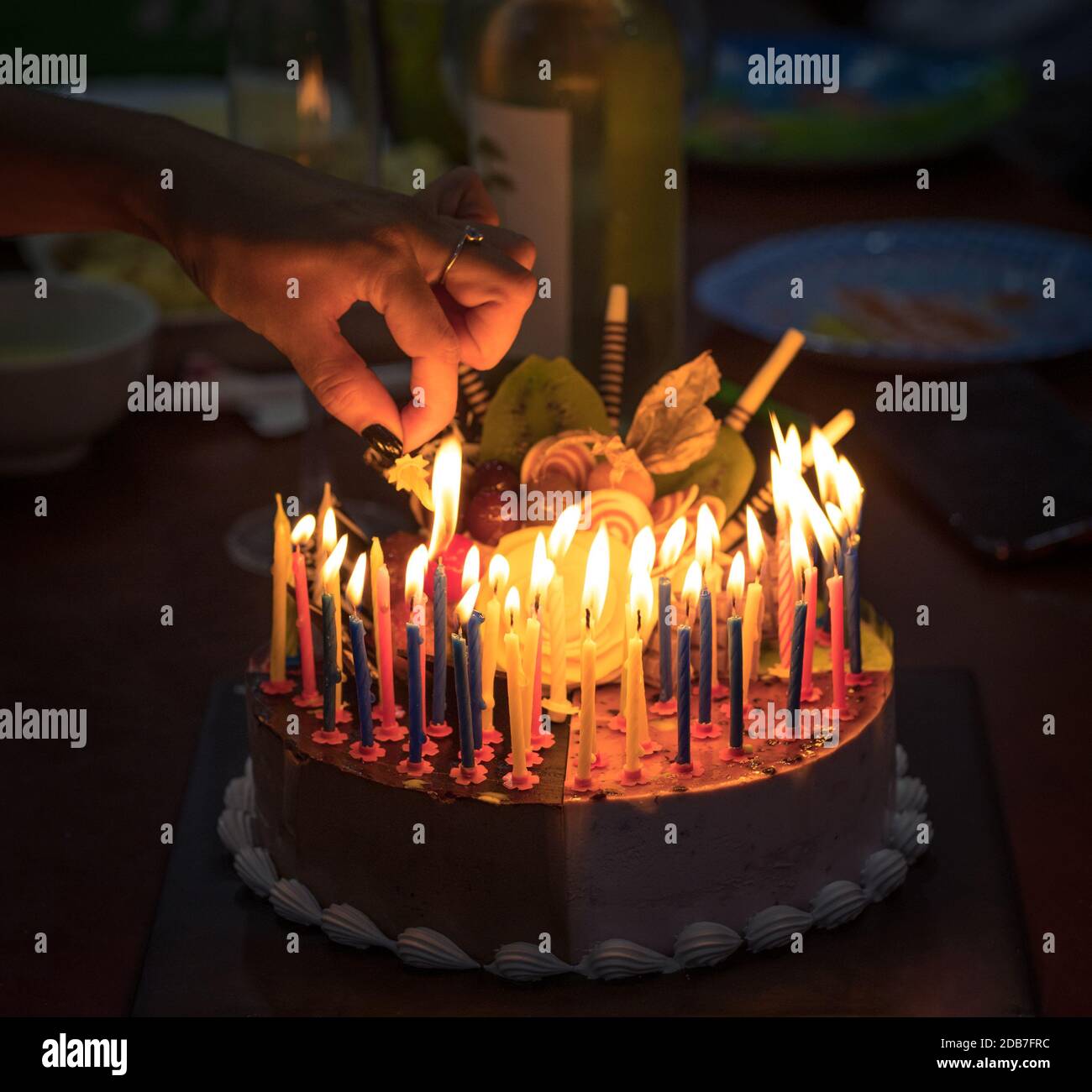Birthday cake with candles in dark Stock Photo - Alamy