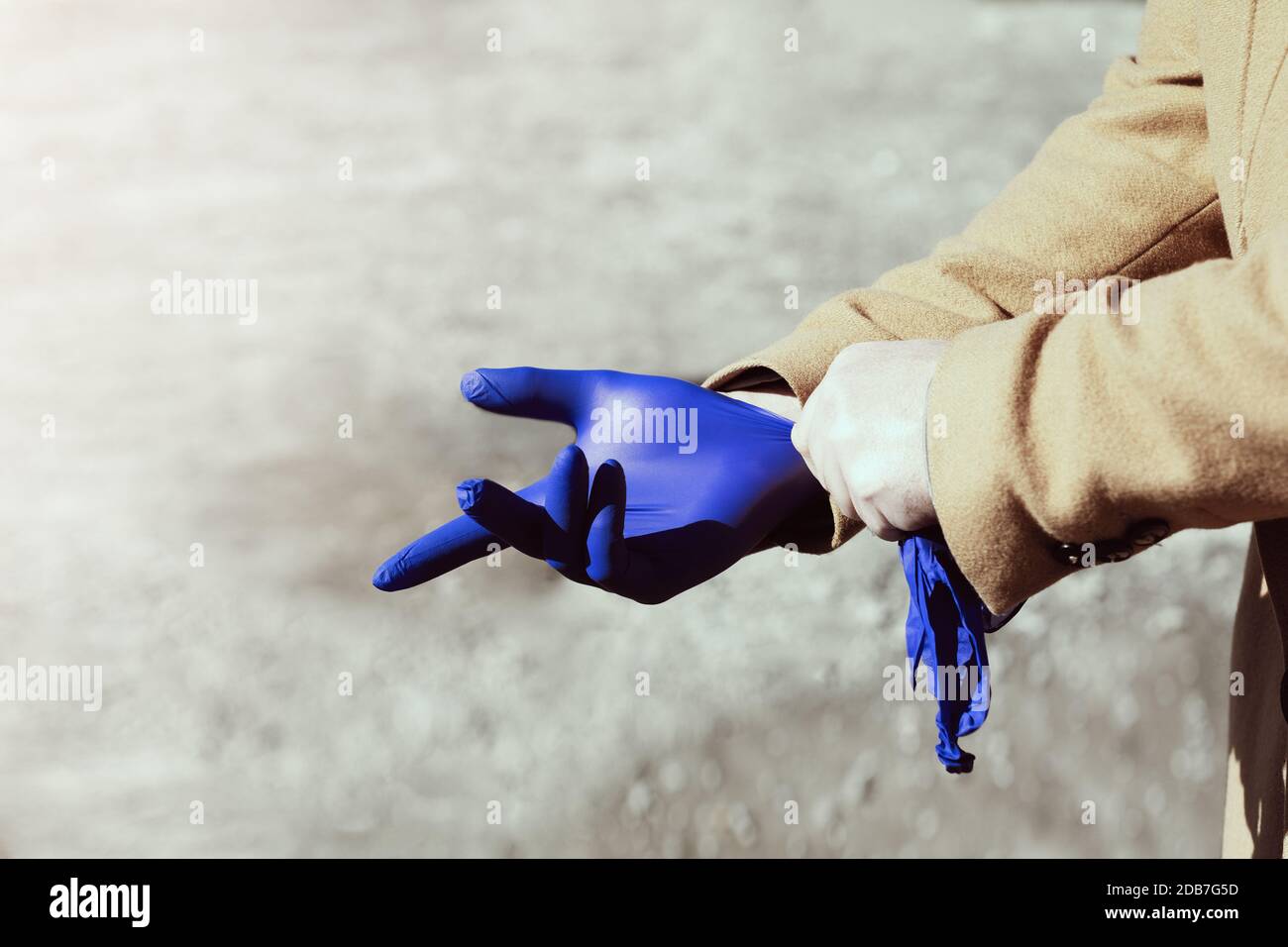Close up to man hands putting on medical gloves for protection from ...