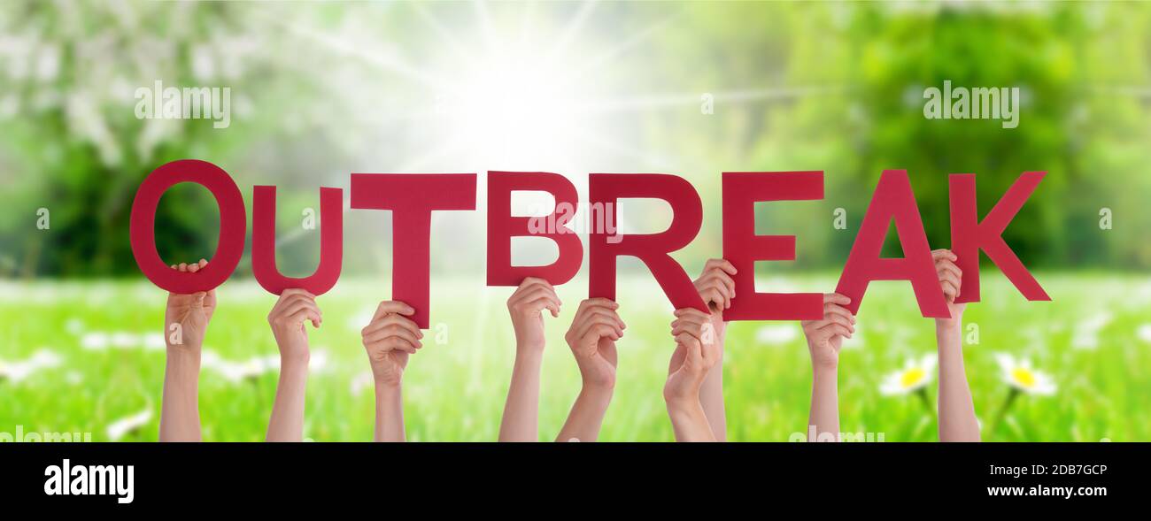 People Hands Holding Colorful English Word Outbreak. Sunny Green Grass ...