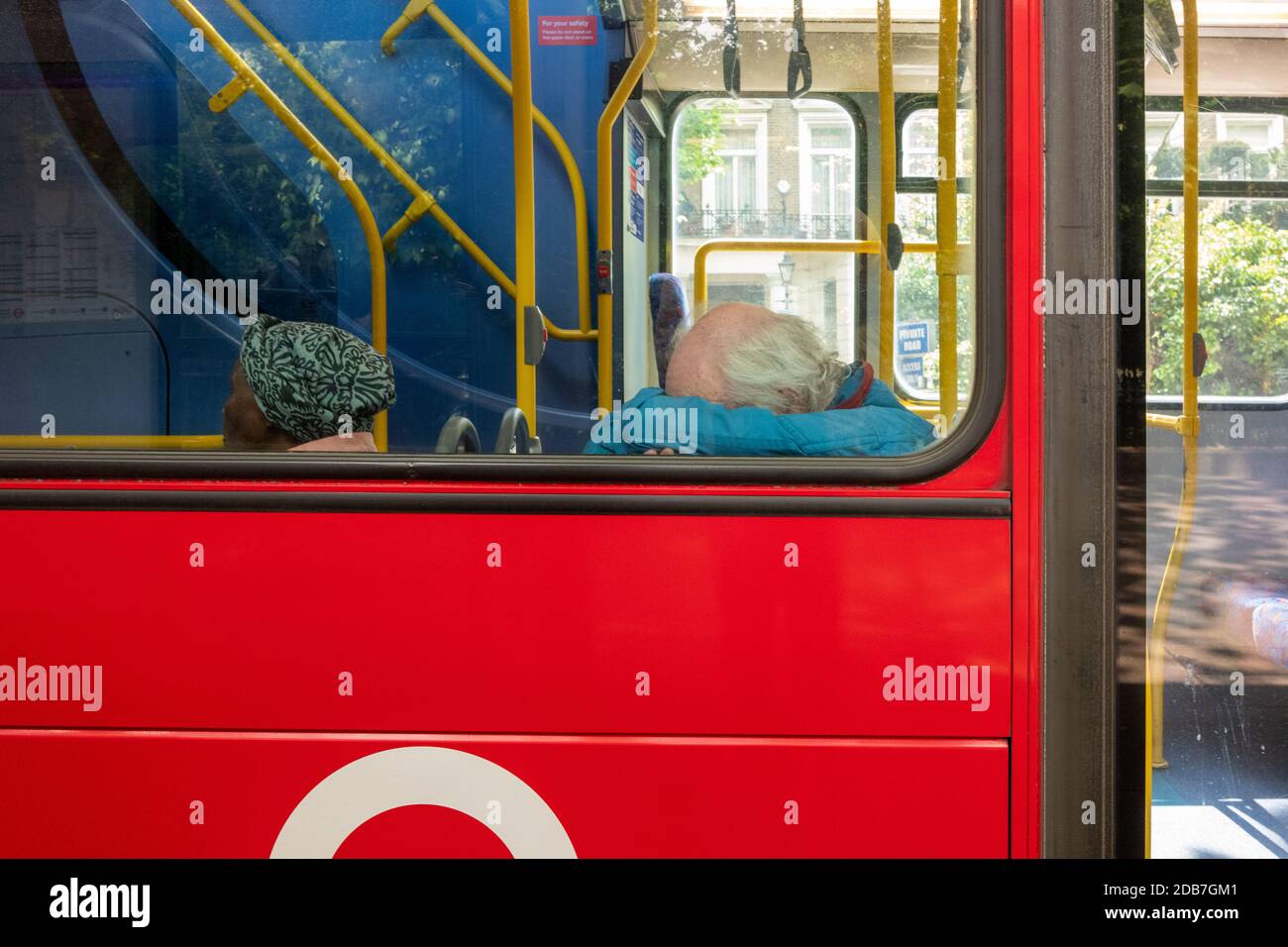 Old person asleep on London double decker bus Stock Photo - Alamy