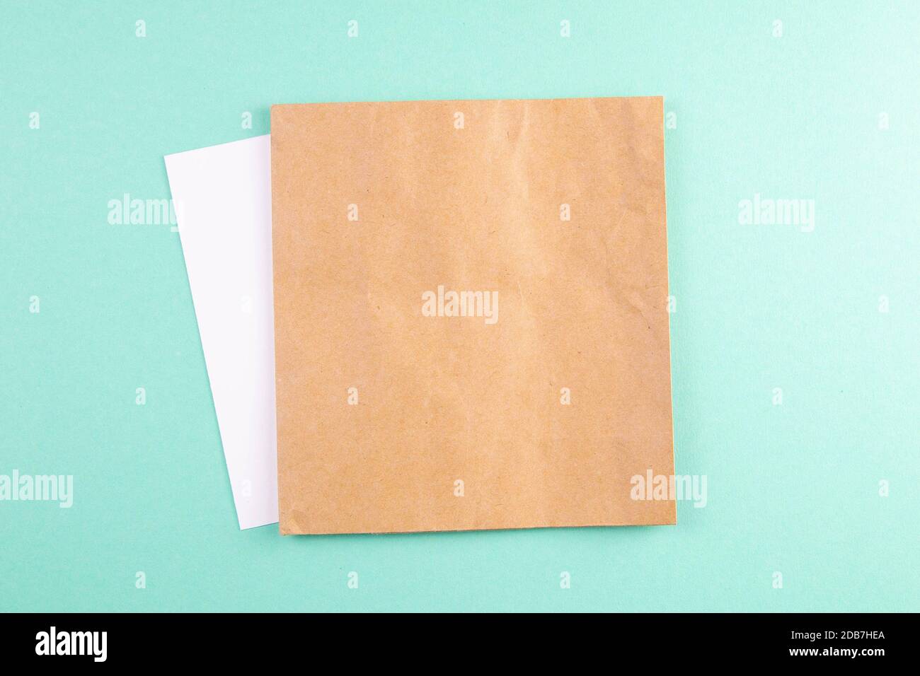 A sheet of craft paper on a mint background Stock Photo - Alamy
