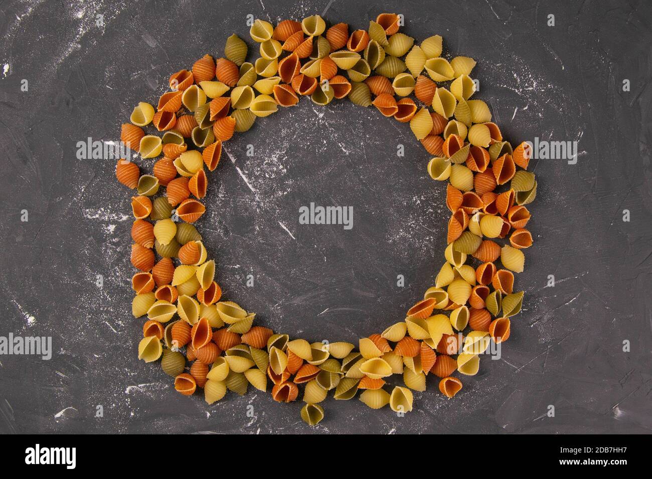 Pasta Conchiglie Rigate, mix of colorful uncooked shells In the shape ...