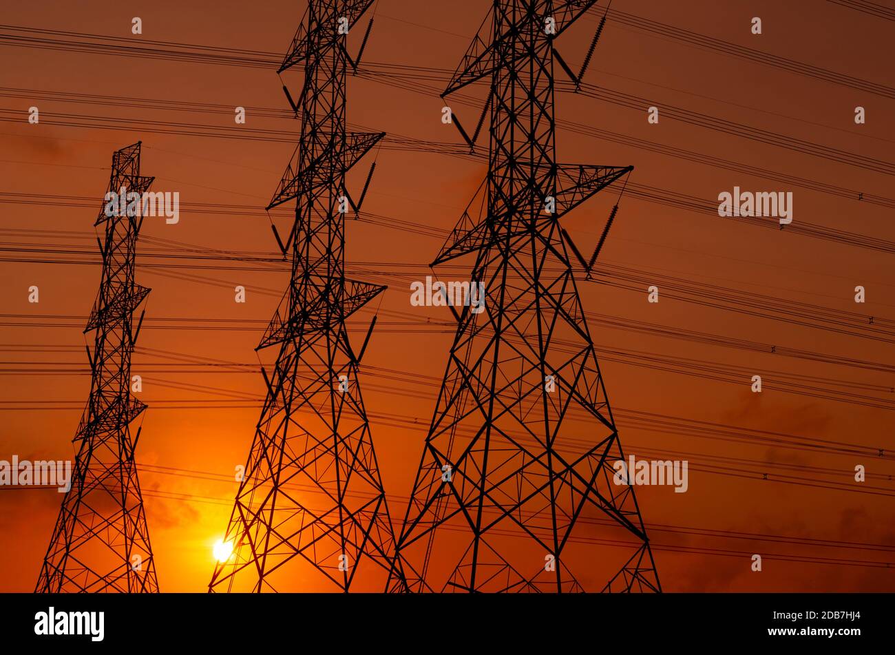 High voltage electric pylon and electrical wire with sunset sky ...