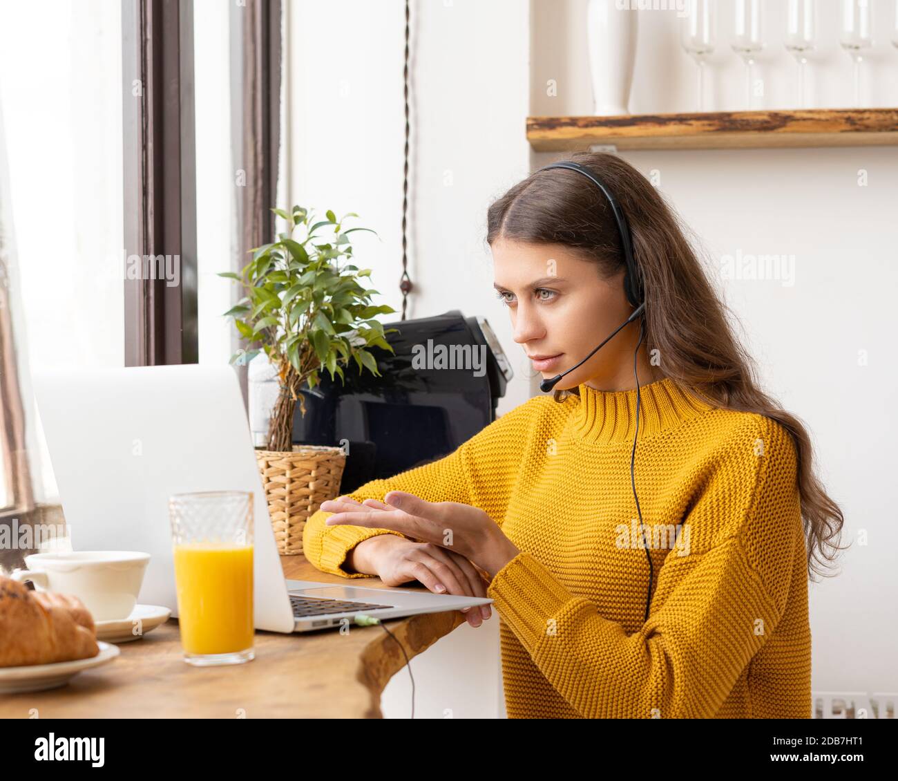 Happy woman in headset speaking by conference call and video chat on ...