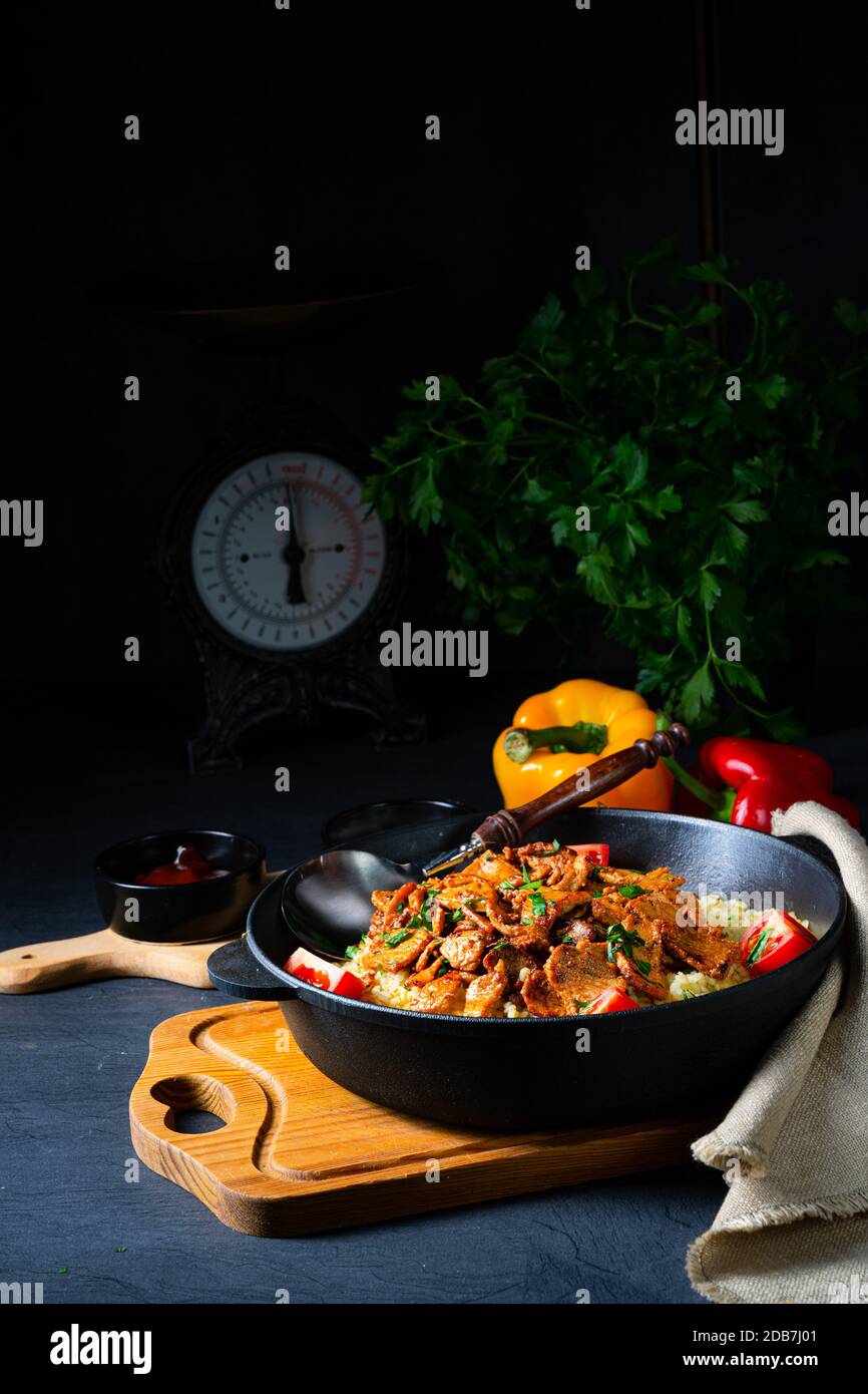 rustic bulgur pans with gratinated gyros and yoghurt Stock Photo - Alamy