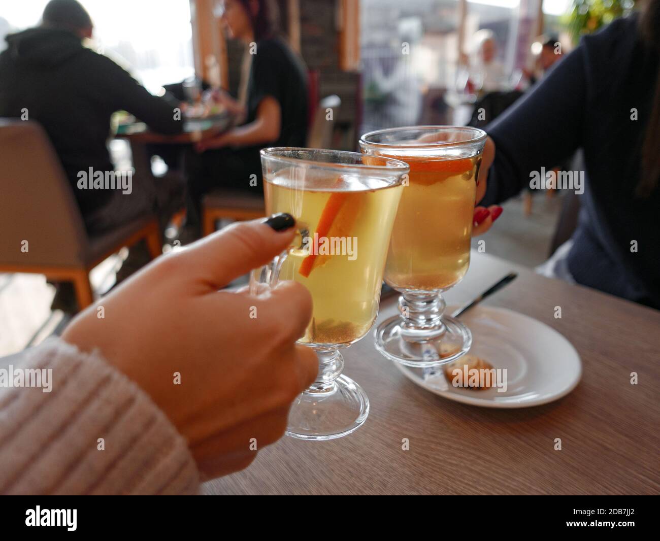 Two females clinking cocktail glasses Stock Photo - Alamy