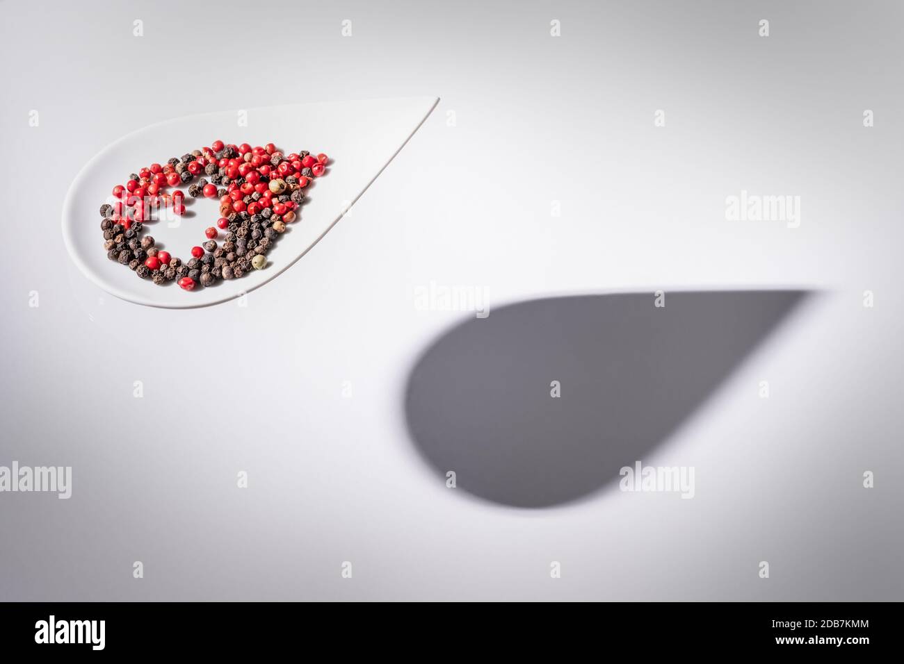 Flying bowl with peppercorns and shadow Stock Photo - Alamy