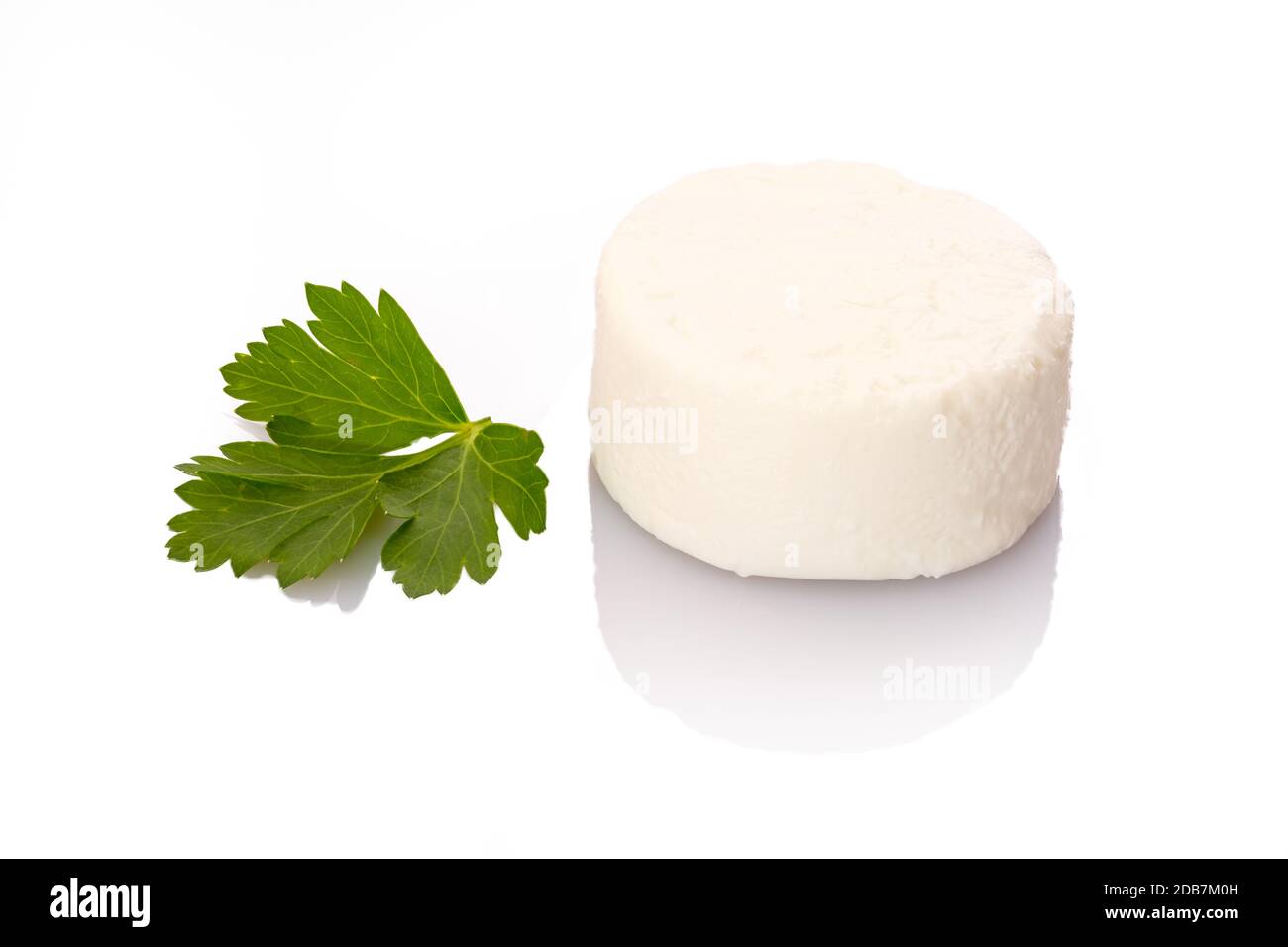 Round goat cheese with parsley leaf white isolated Stock Photo - Alamy