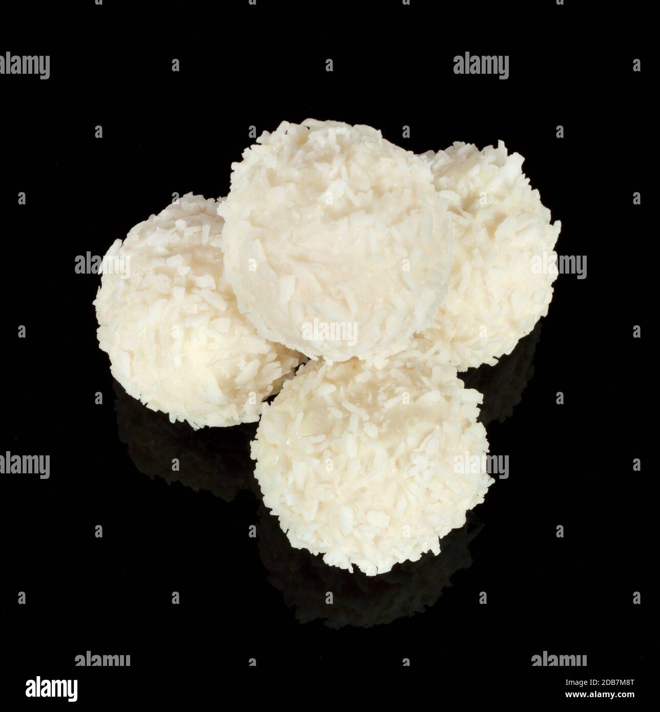 White sweet candy stacked pyramid on a black background Stock Photo - Alamy