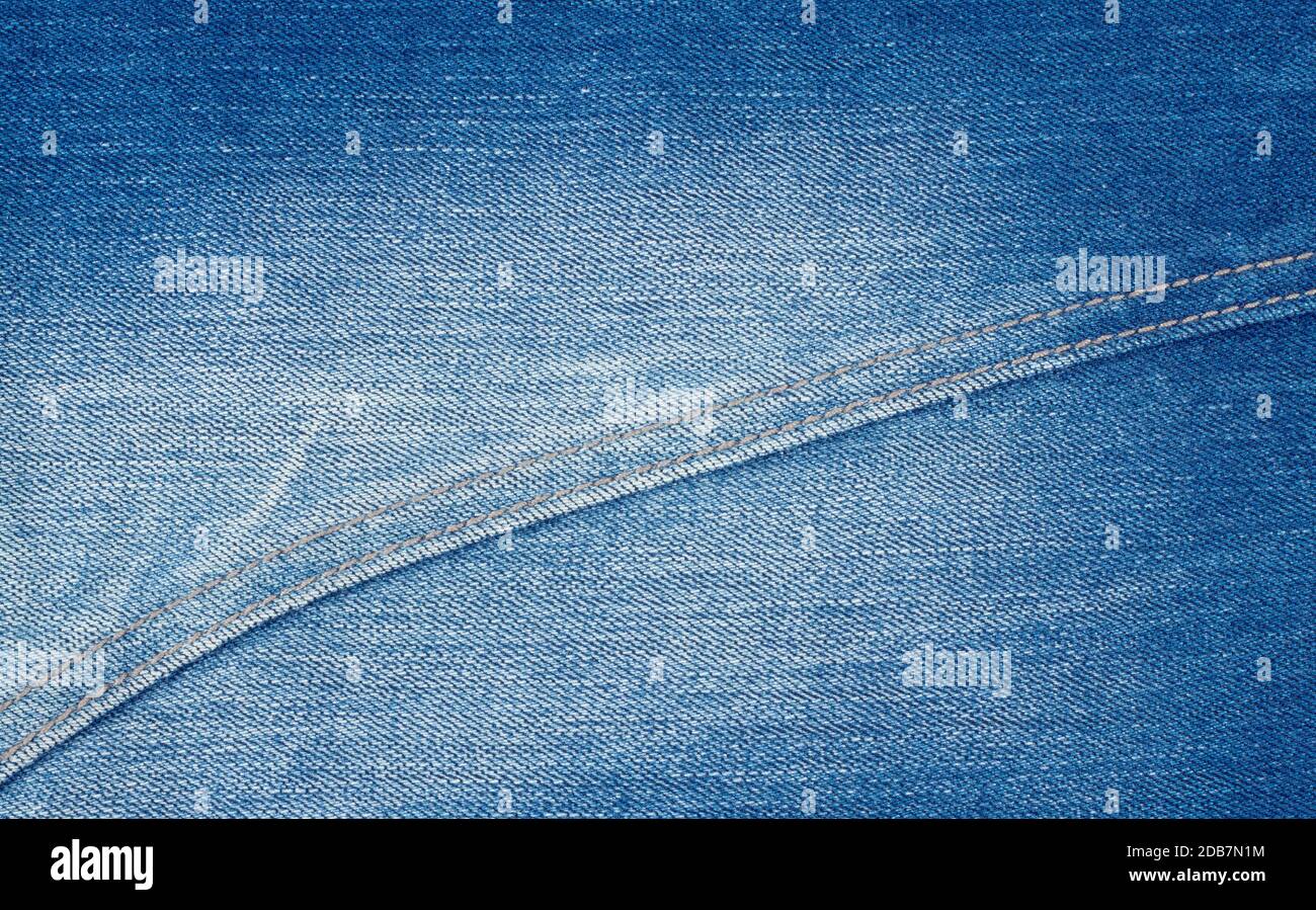 Bleached denim blue background with a seam Stock Photo - Alamy
