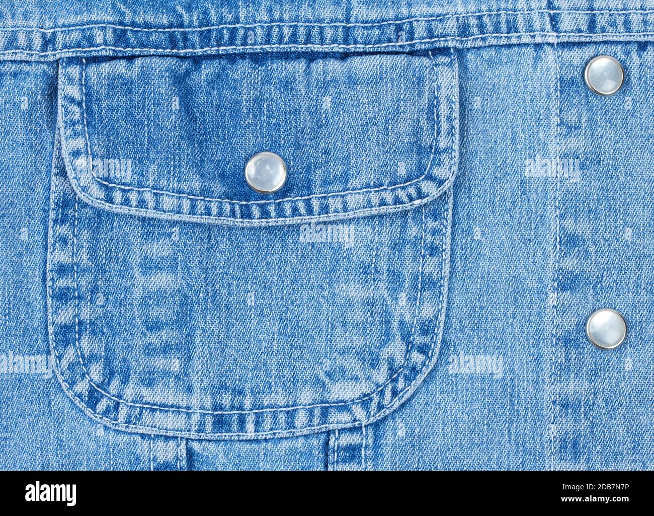 Pocket with buttons on the blue denim Stock Photo - Alamy