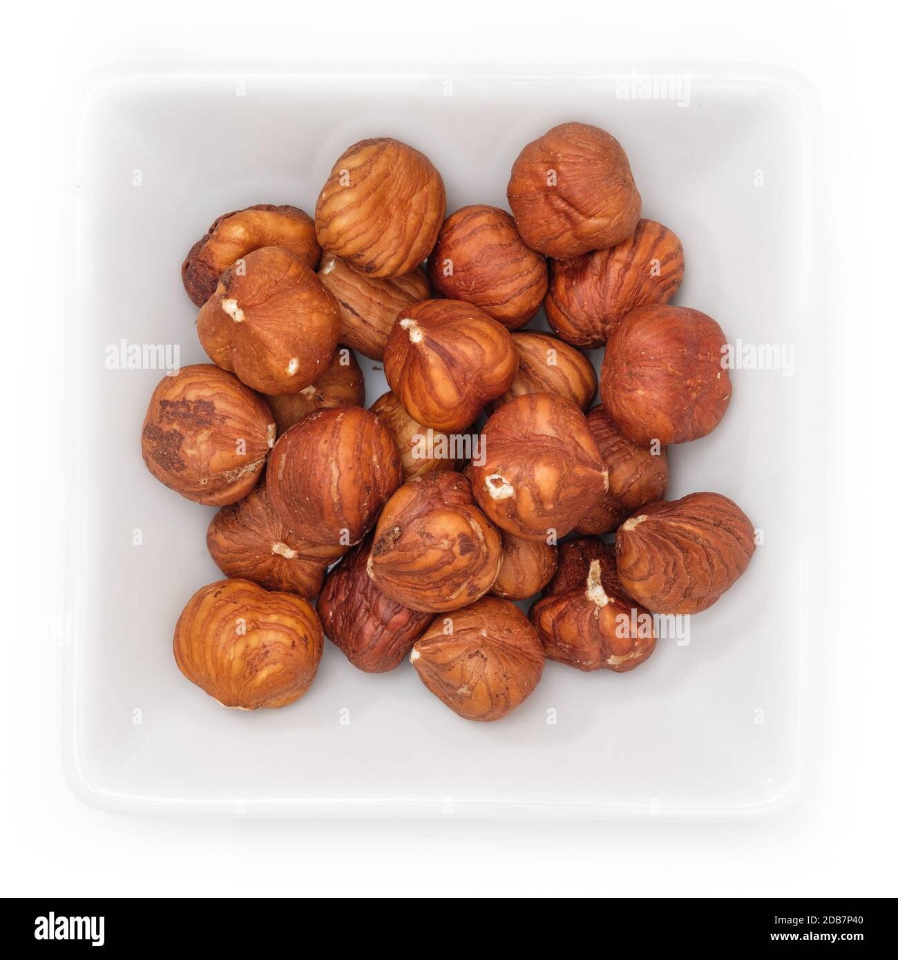 Hazelnuts nuts brown in a bowl in top view Stock Photo - Alamy