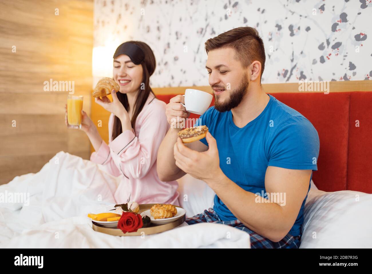 Romantic love couple, breakfast in bed at home, good morning, caring ...