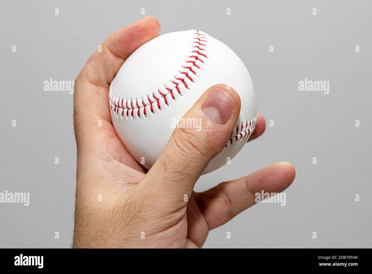 baseball ball white sport hand holding game Stock Photo - Alamy