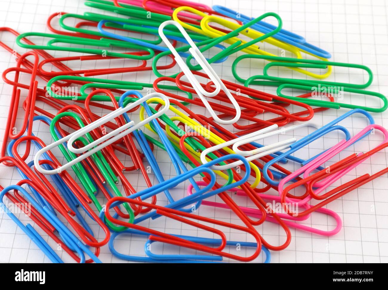 Color clips on checked paper Stock Photo - Alamy