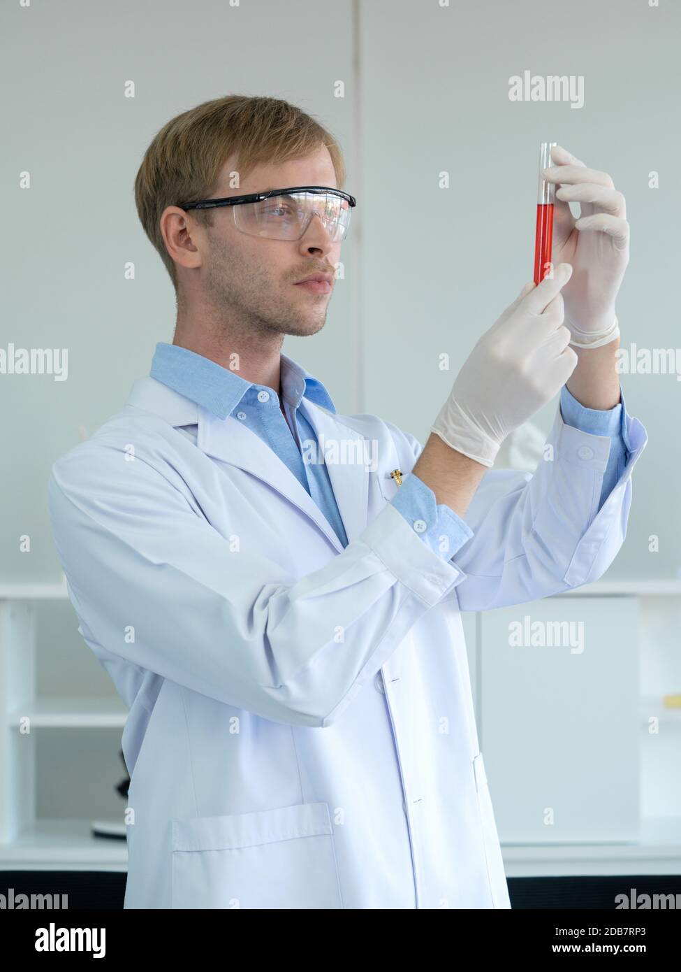 A young brazilian scientist with lab safety goggles is considering the ...