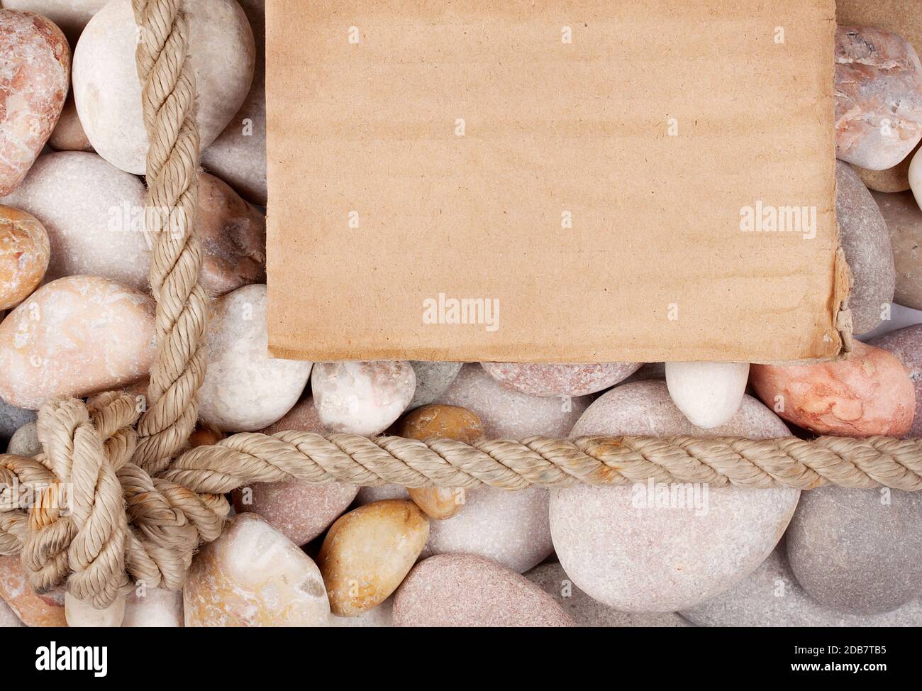 Background with sea pebbles rope and cardboard Stock Photo - Alamy