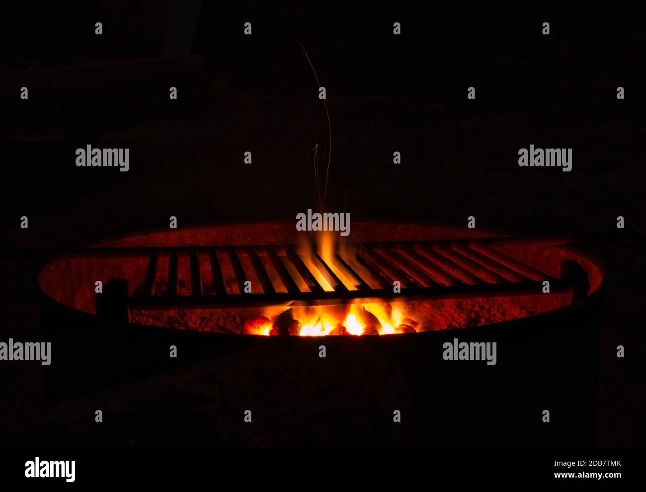 A round fireplace with grill on a camping site Stock Photo - Alamy
