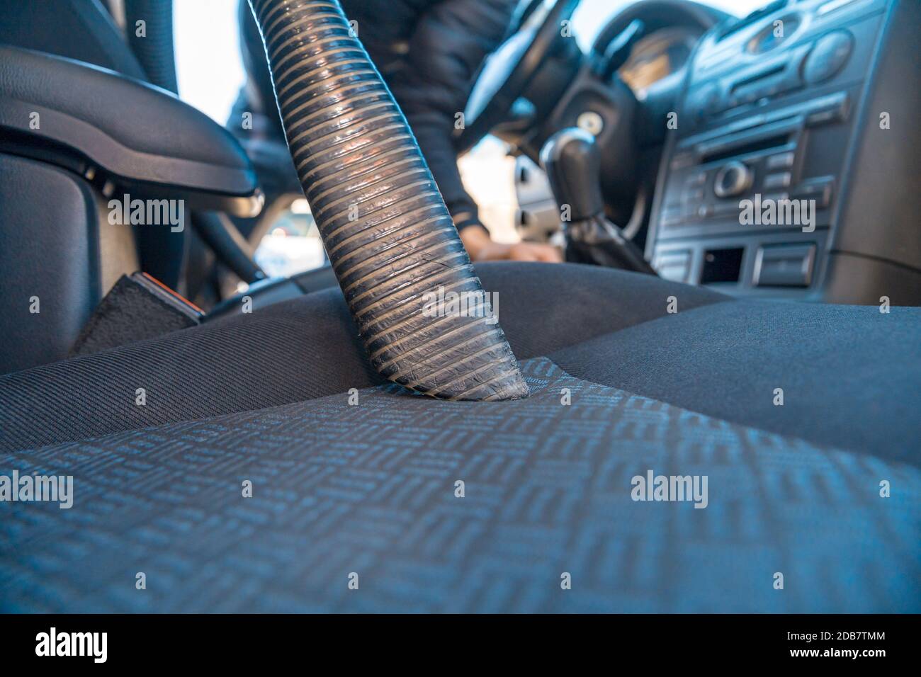 vehicle interior vacuum cleaning. Detail shot of an industrial vacuum ...
