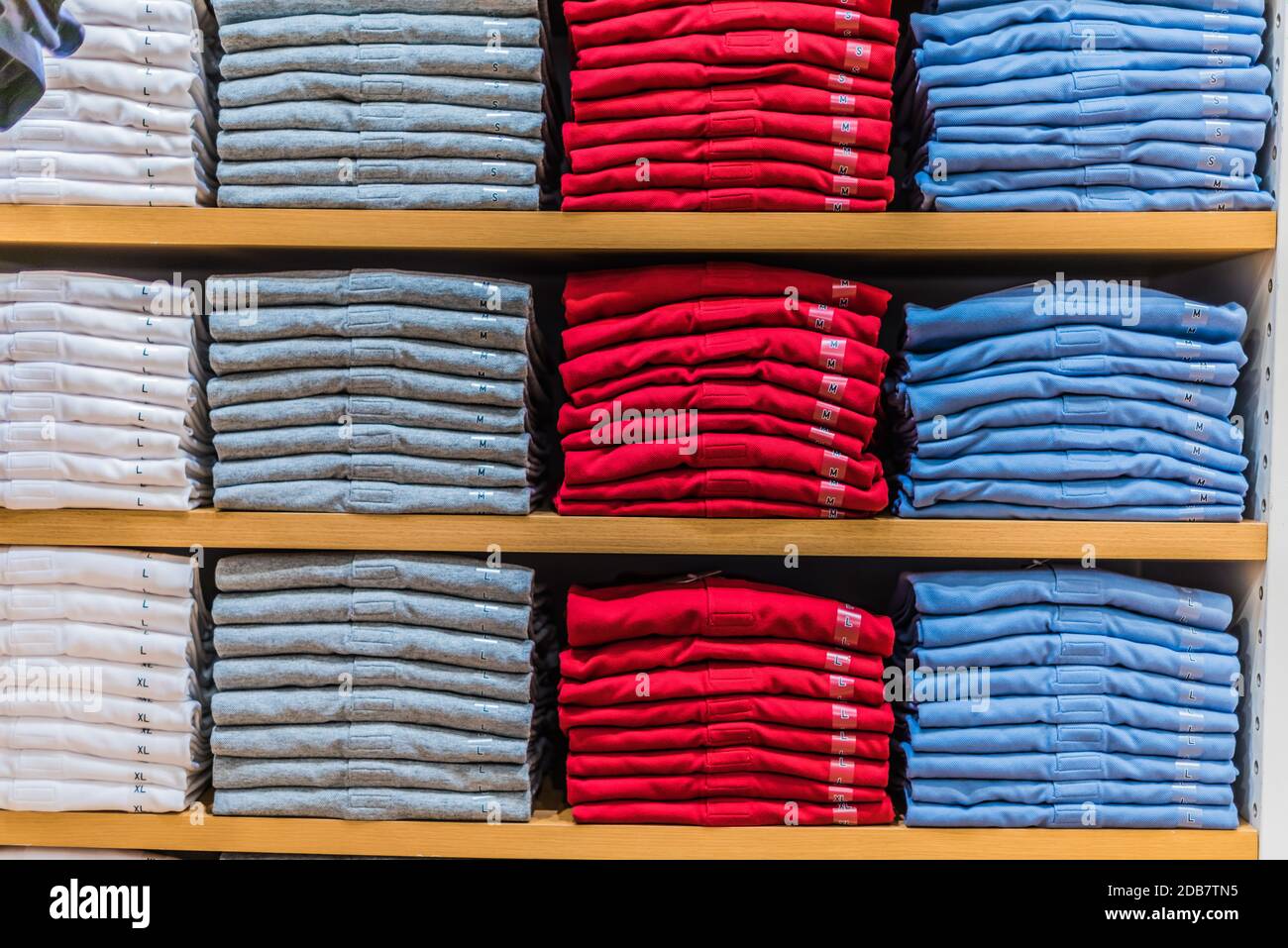 Clothing products on the shelf in a clothing store Stock Photo - Alamy
