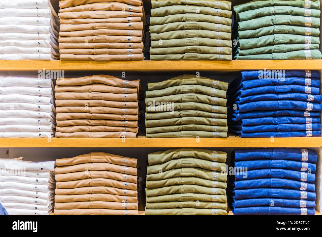 Clothing products on the shelf in a clothing store Stock Photo - Alamy