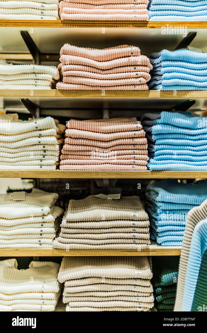 Clothing products on the shelf in a clothing store Stock Photo - Alamy