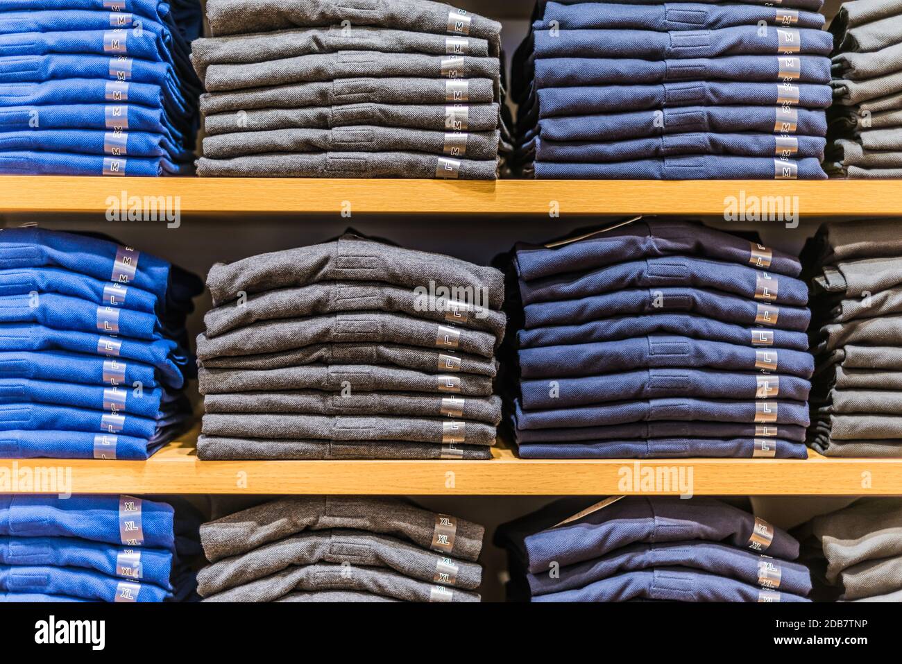 Clothing products on the shelf in a clothing store Stock Photo - Alamy