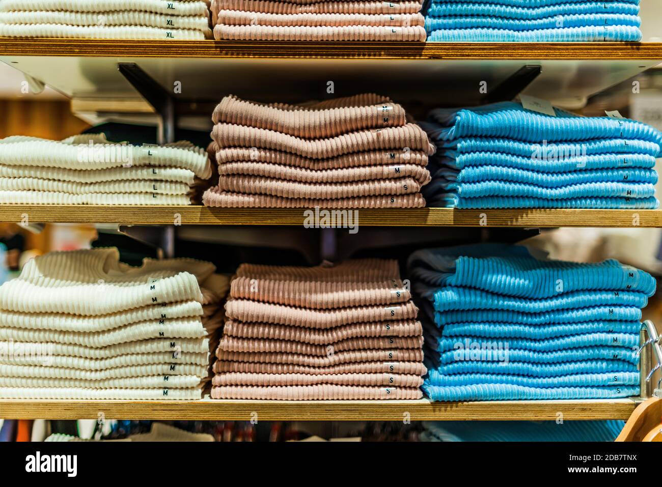 Clothing products on the shelf in a clothing store Stock Photo - Alamy