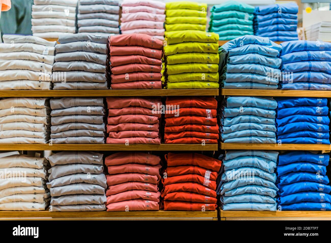 Clothing products on the shelf in a clothing store Stock Photo - Alamy