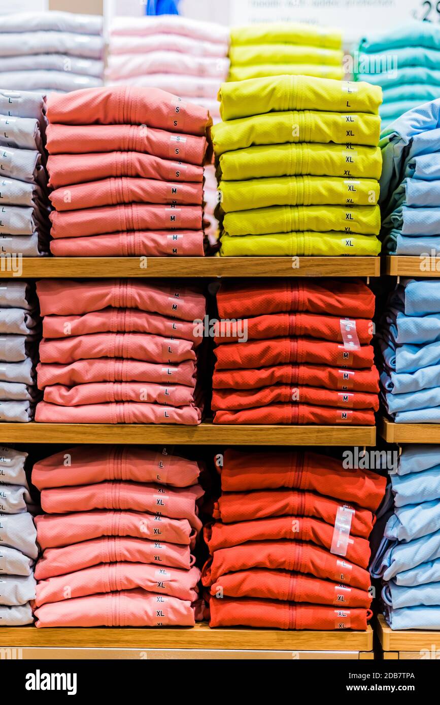 Clothing products on the shelf in a clothing store Stock Photo - Alamy