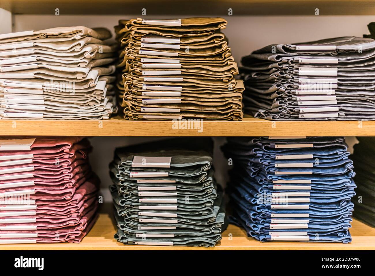 Clothing products on the shelf in a clothing store Stock Photo - Alamy