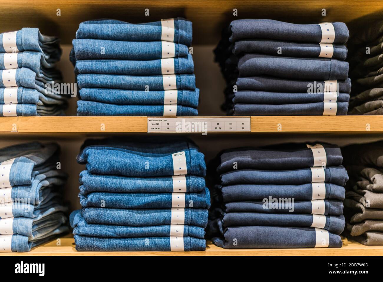 Clothing products on the shelf in a clothing store Stock Photo - Alamy