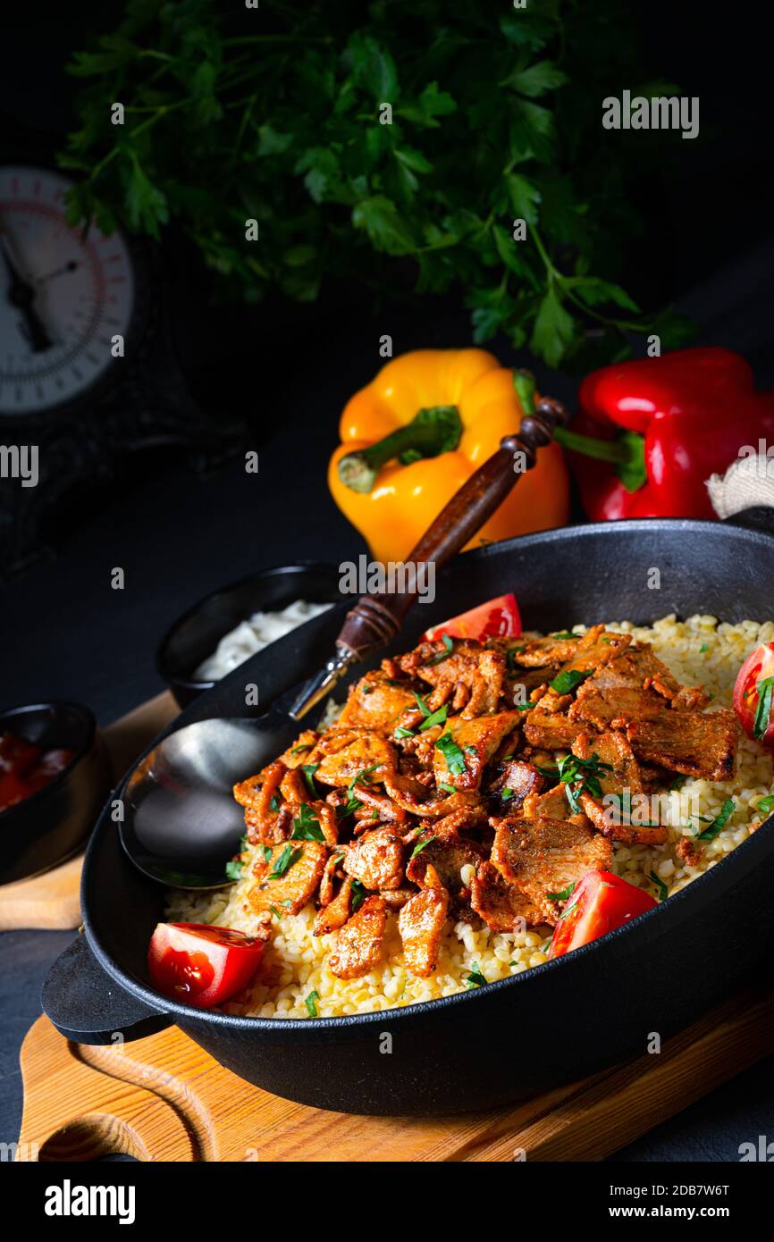 rustic bulgur pans with gratinated gyros and yoghurt Stock Photo - Alamy