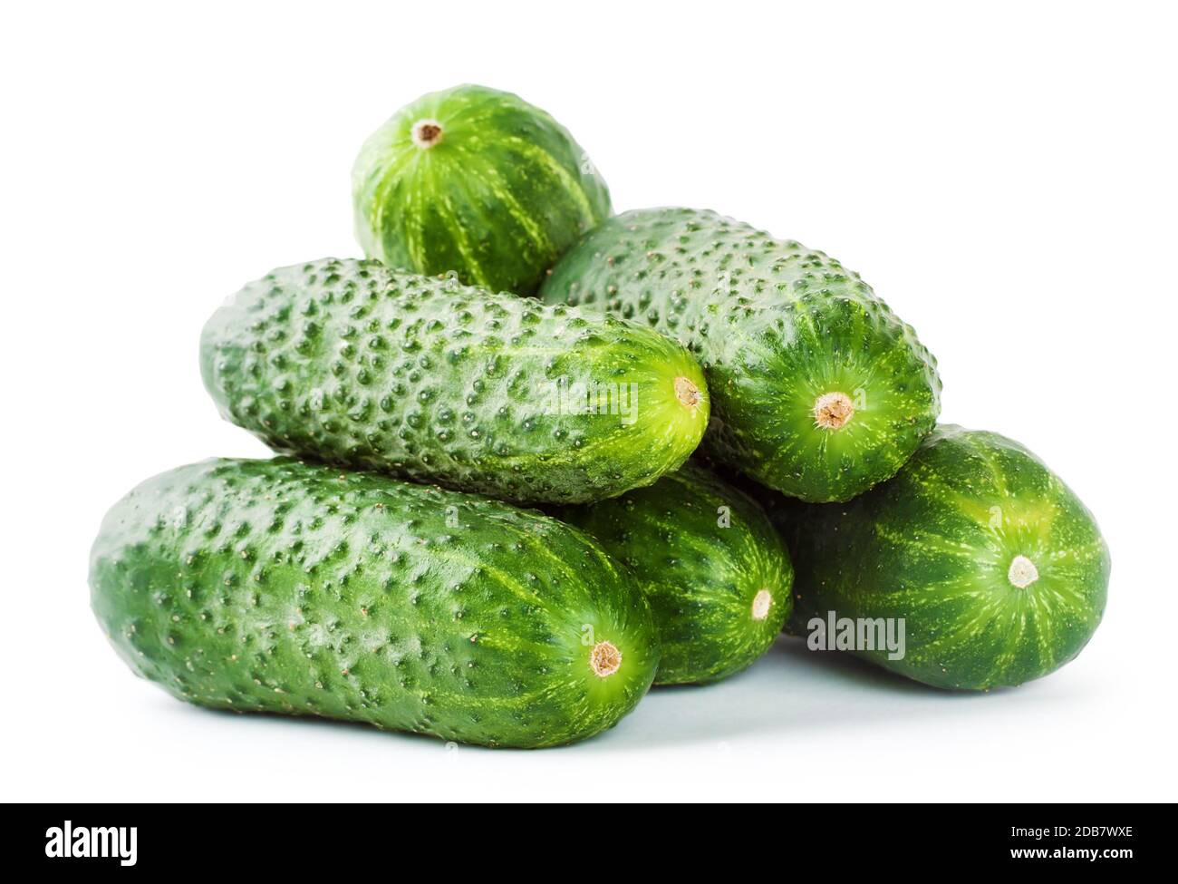 Pile of green cucumbers isolated on white background Stock Photo - Alamy
