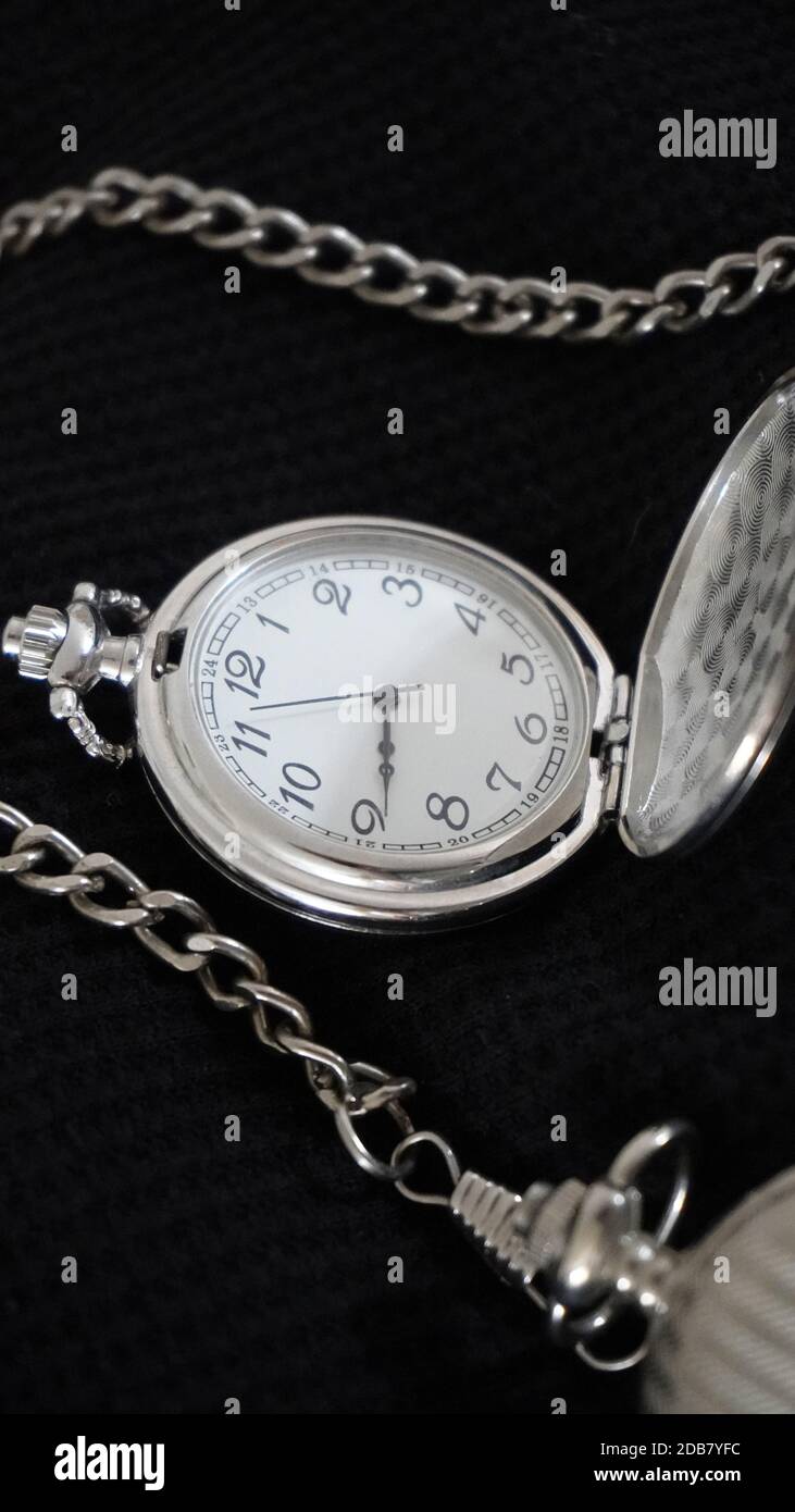 Old antique pocket watch with chain on black material. Time concept ...