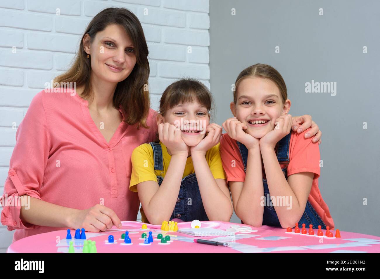 Portrait of a happy family playing board games at a table Stock Photo ...