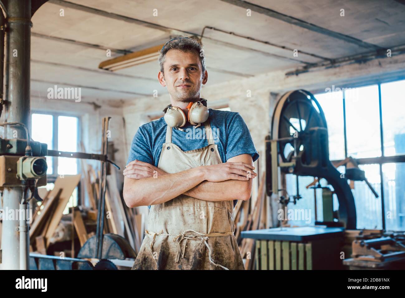 Carpenter standing in his vintage wood workshop looking at camera Stock ...