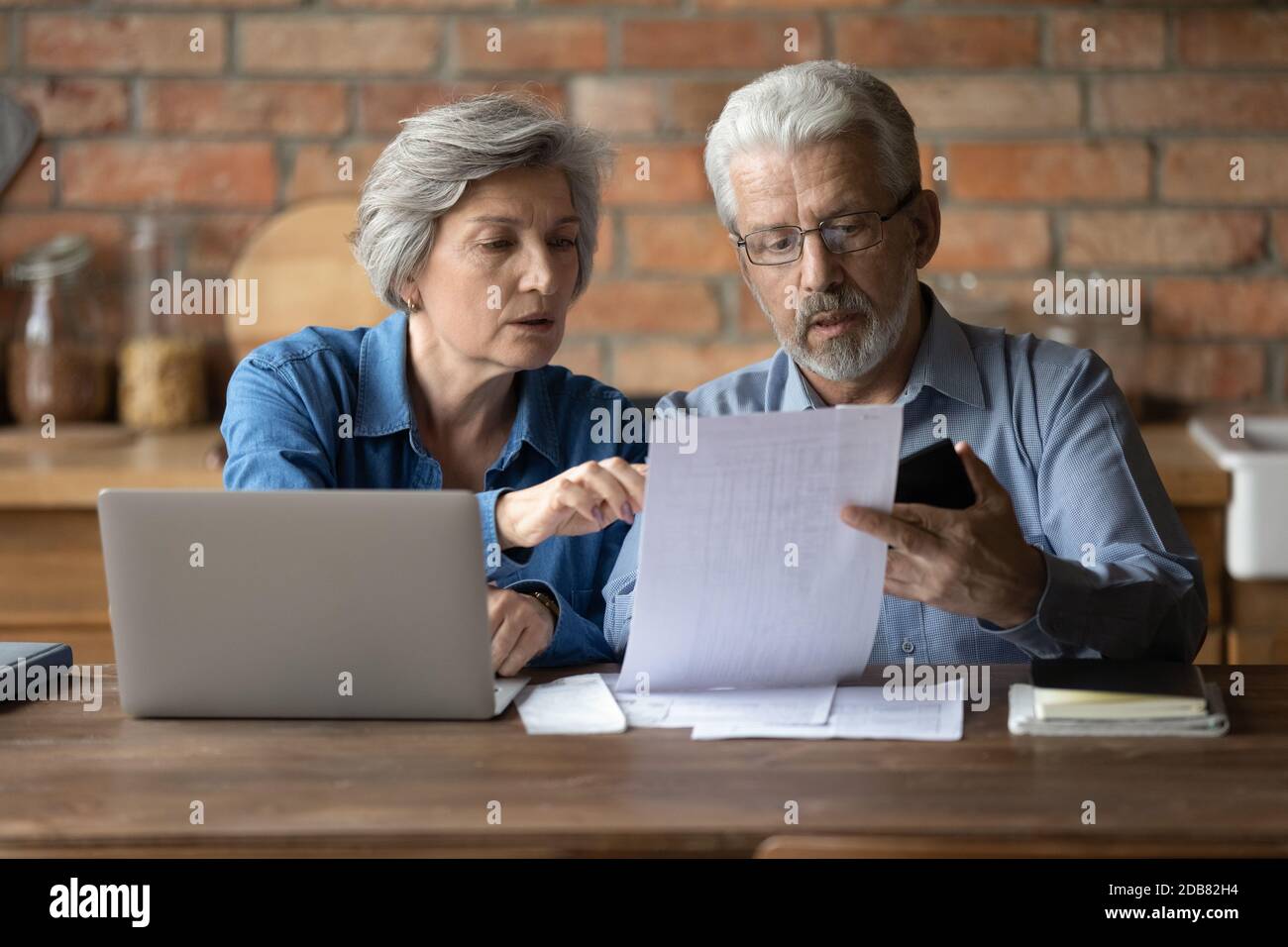 Mature couple checking bills hi-res stock photography and images - Alamy
