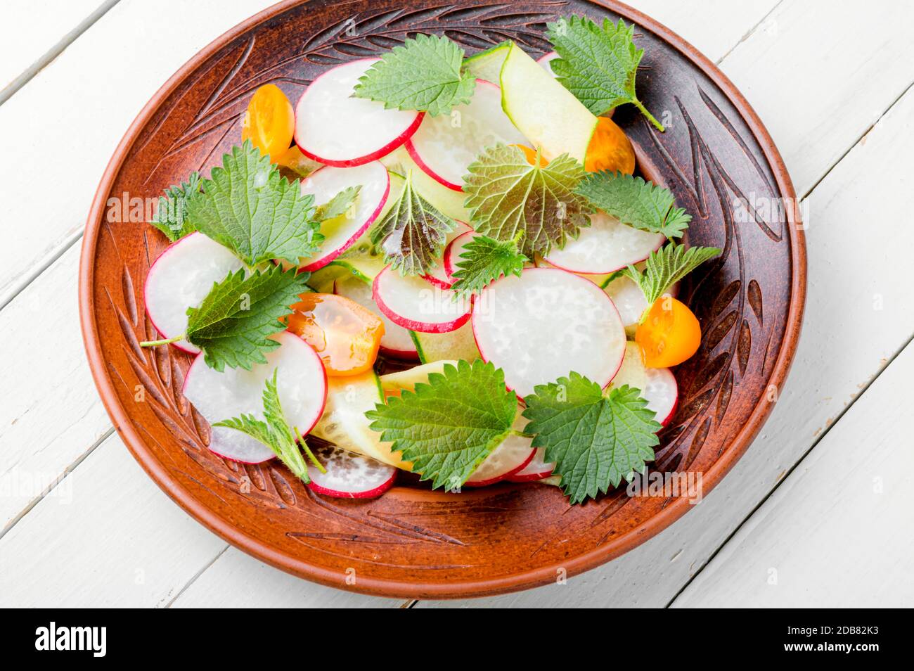 Healthy vegetable salad of nettle on plate.Fresh spring salad Stock ...