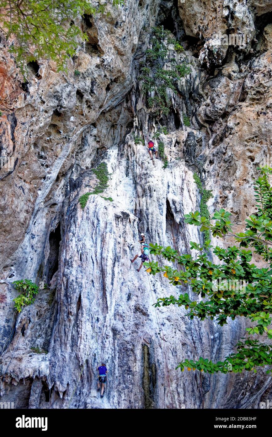 People climbing with the rope protection at Phra Nang Cave Beach ...