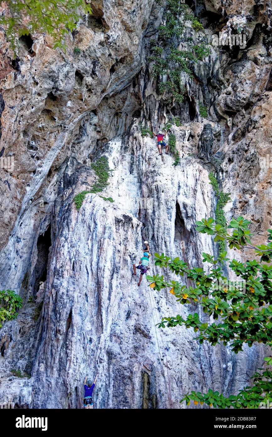People climbing with the rope protection at Phra Nang Cave Beach ...