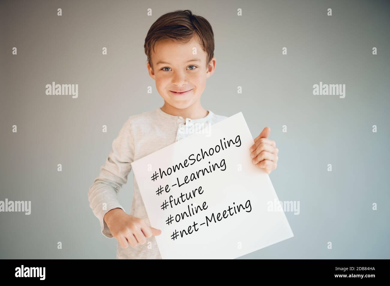 boy holding white sign with the words homeschooling and more in front ...
